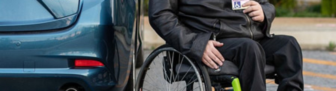 young-man-in-wheelchair-holding-up-his-acrod-permit | ACROD