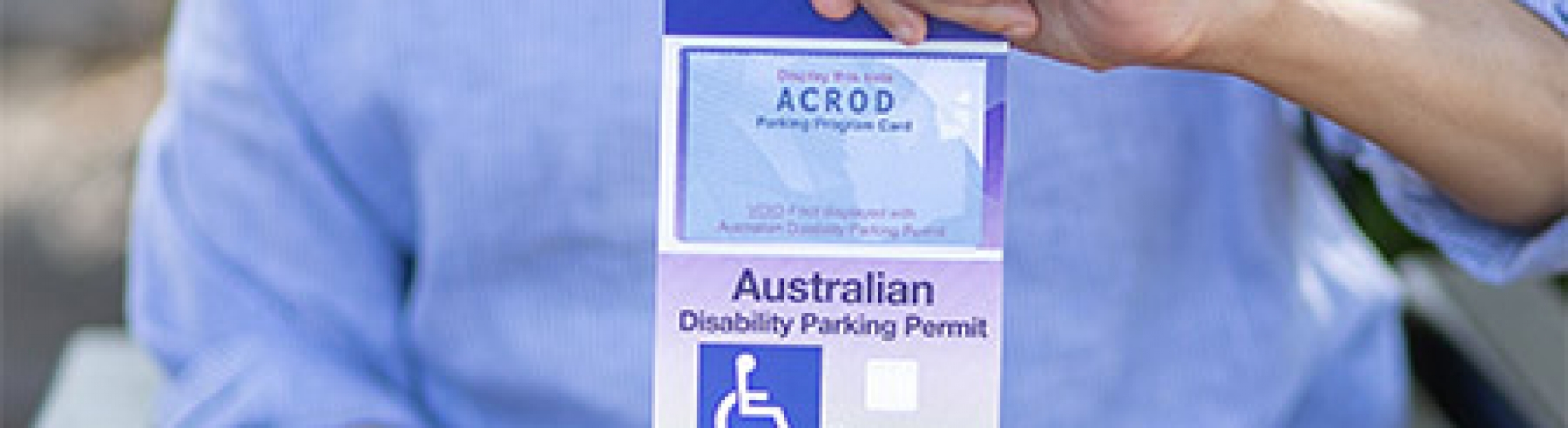 young-woman-holding-up-acrod-permit | ACROD